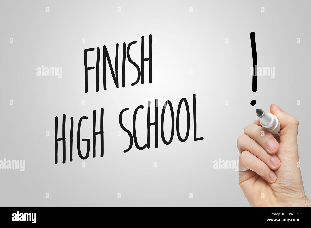 Hand writing finish high school on grey background Stock Photo - Alamy