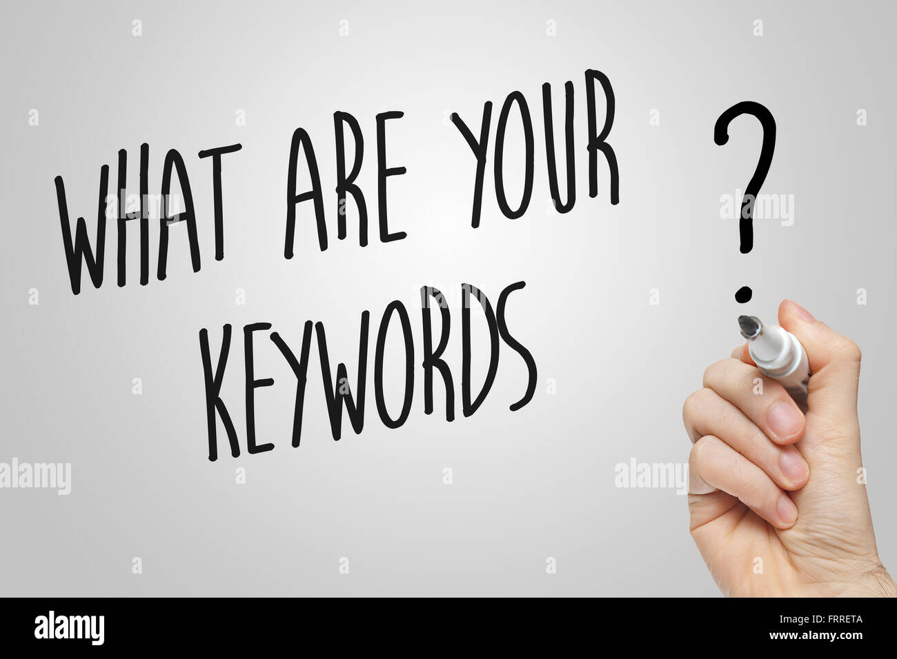 Hand writing what are your keywords on grey background Stock Photo - Alamy