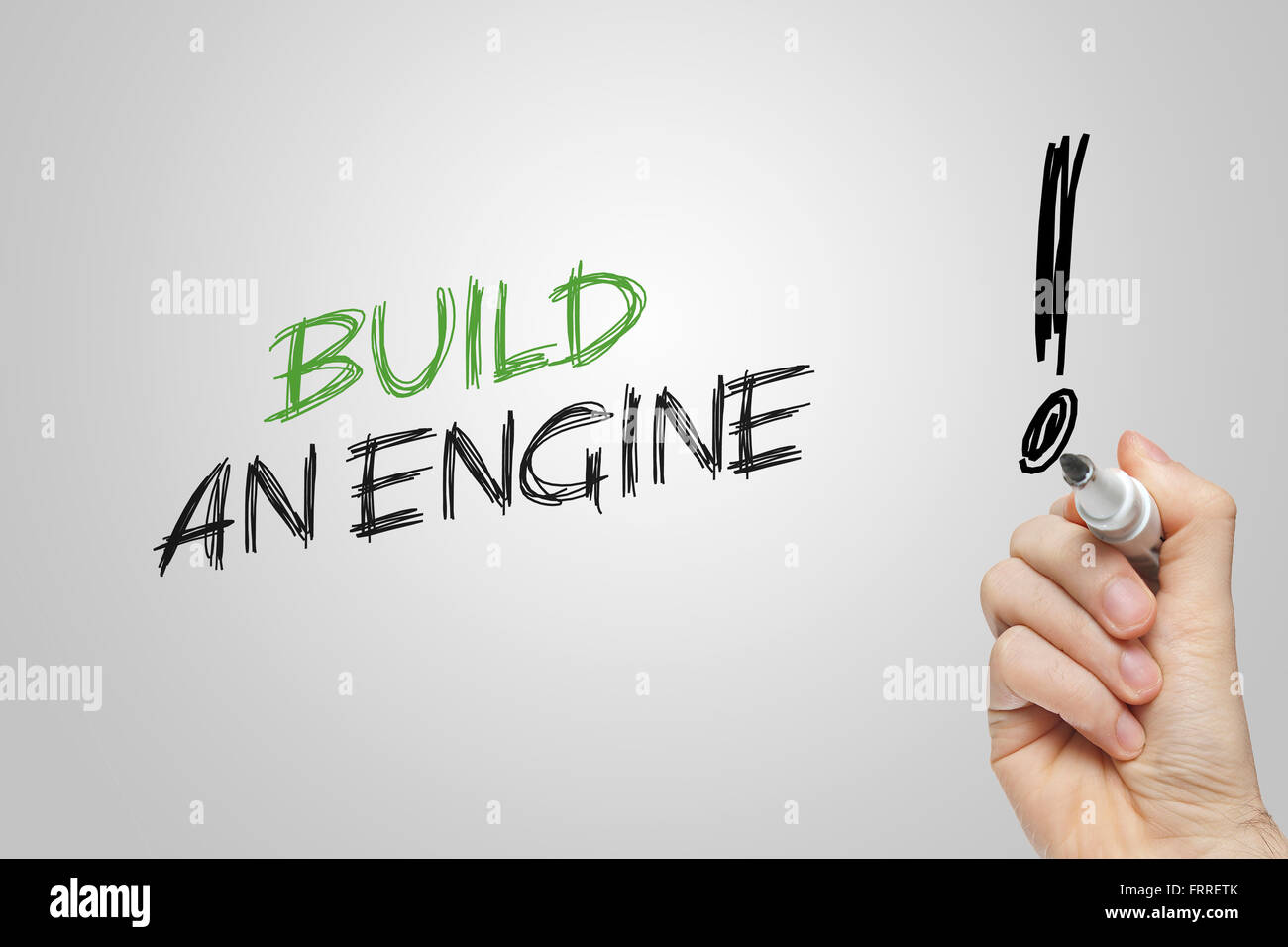 Hand writing build an engine on grey background Stock Photo - Alamy