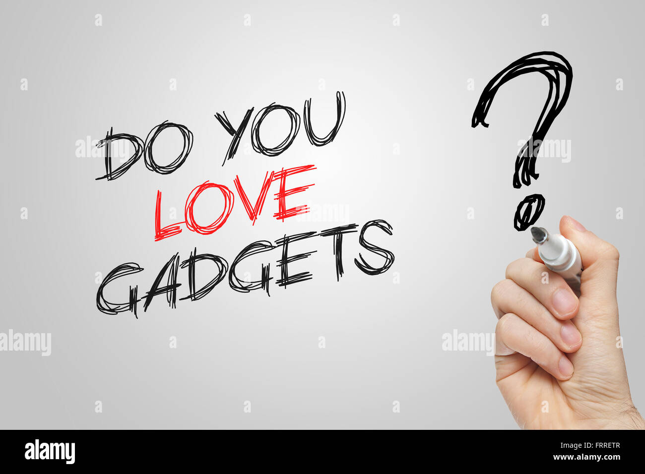 Hand writing do you love gadgets on grey background Stock Photo - Alamy