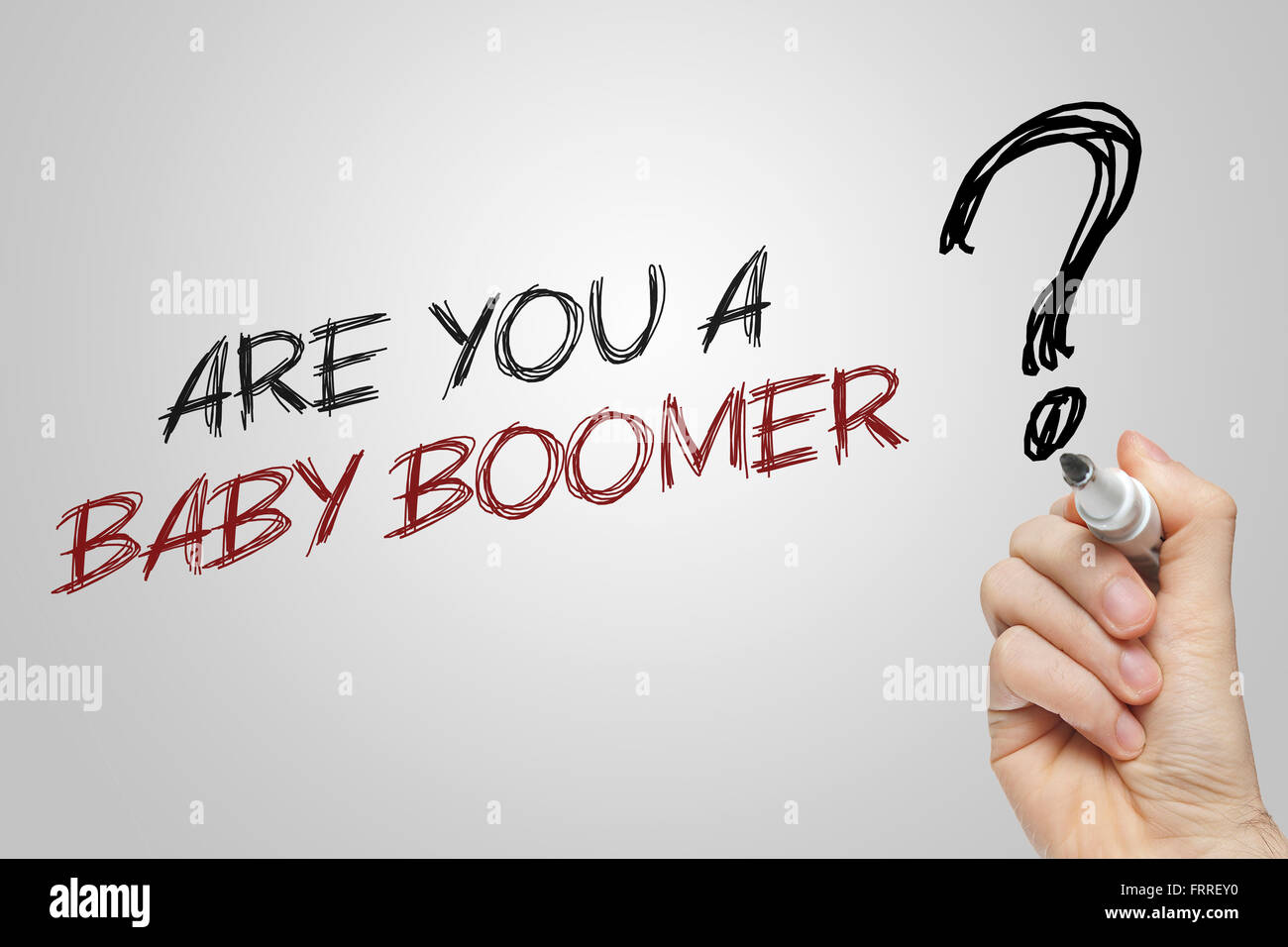 Hand writing are you a baby boomer on grey background Stock Photo - Alamy