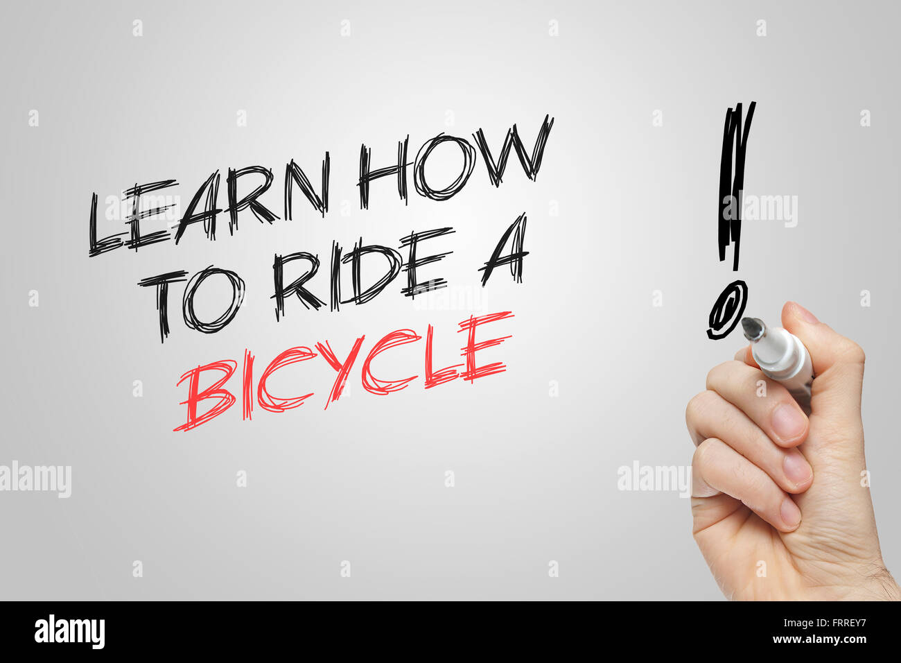 Hand writing learn how to ride a bicycle on grey background Stock Photo ...