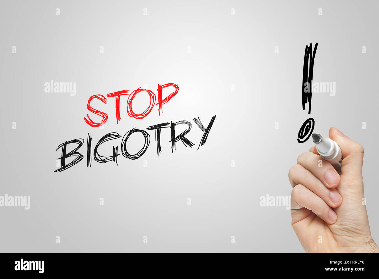 Hand writing stop bigotry on grey background Stock Photo - Alamy