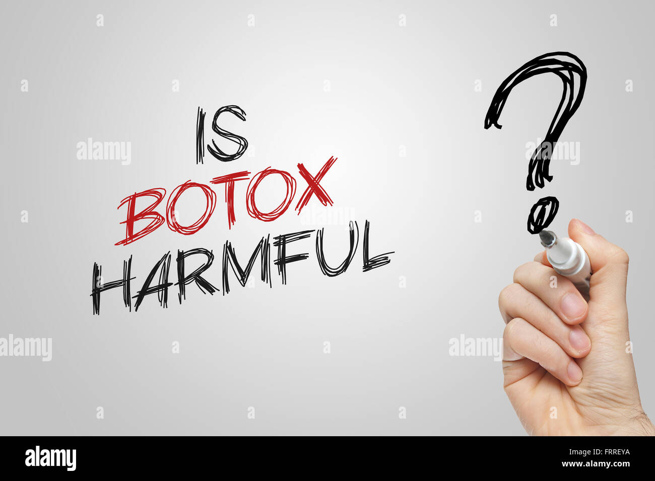 Hand writing is botox harmful on grey background Stock Photo - Alamy