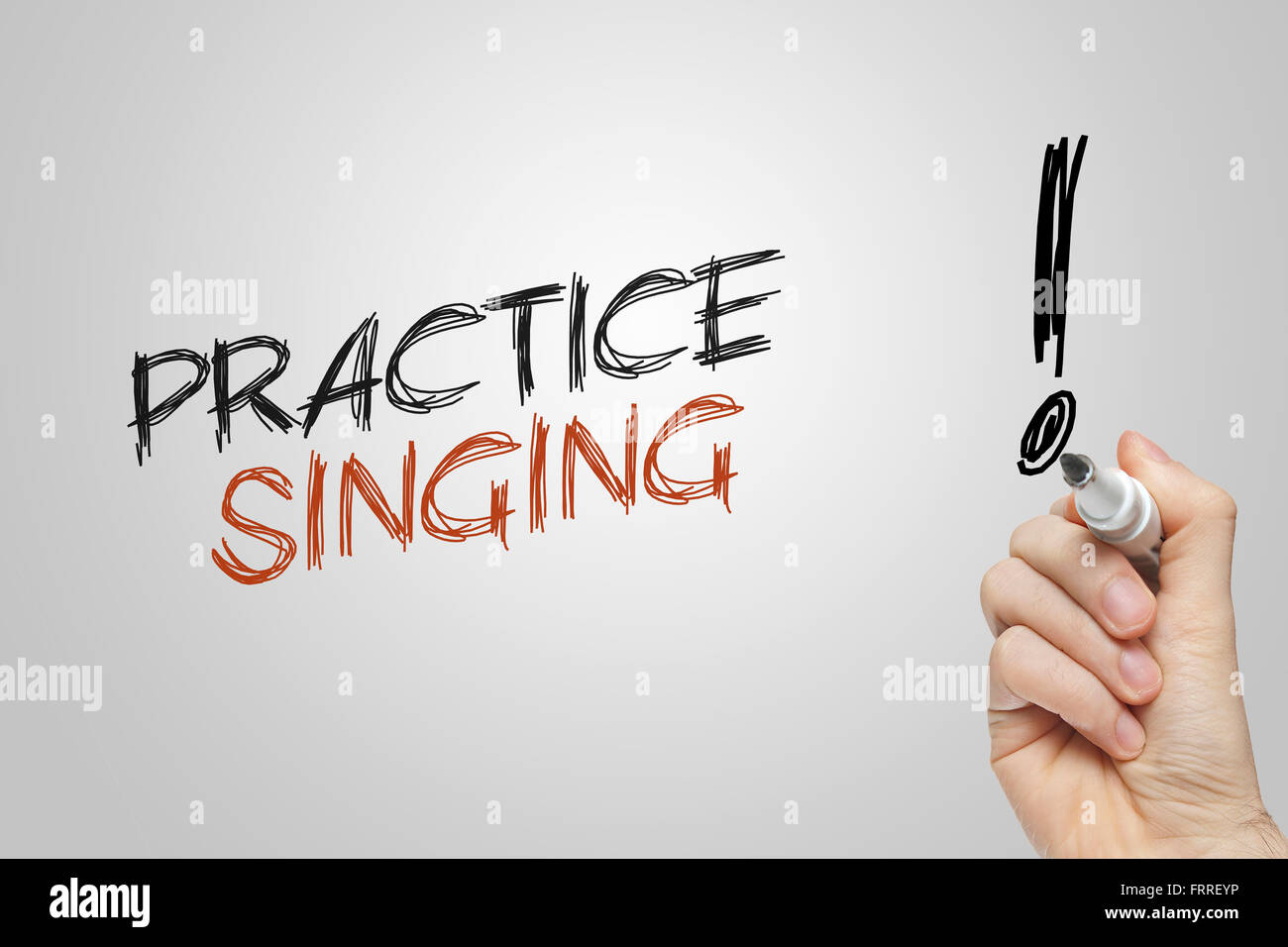 Hand writing practice singing on grey background Stock Photo - Alamy