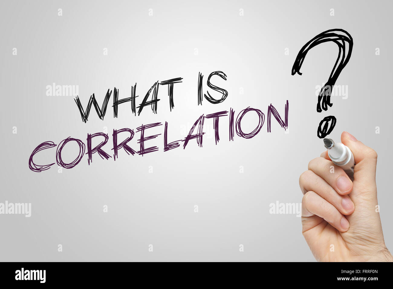 Hand writing what is correlation on grey background Stock Photo - Alamy