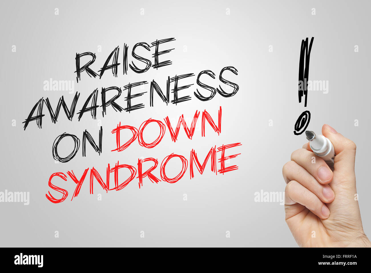 Hand writing raise awareness on down syndrome on grey background Stock ...