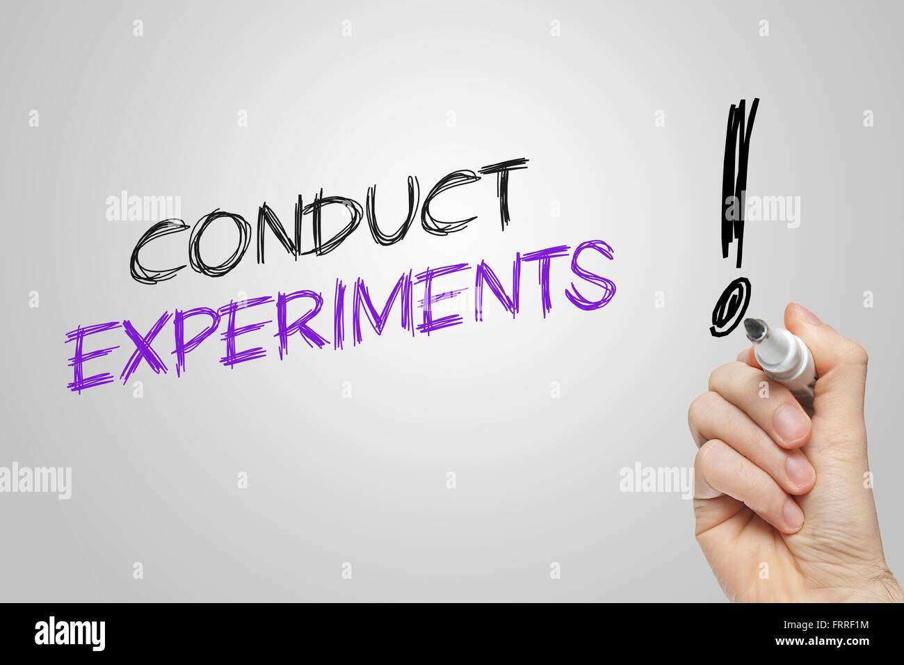 Hand writing conduct experiments on grey background Stock Photo - Alamy