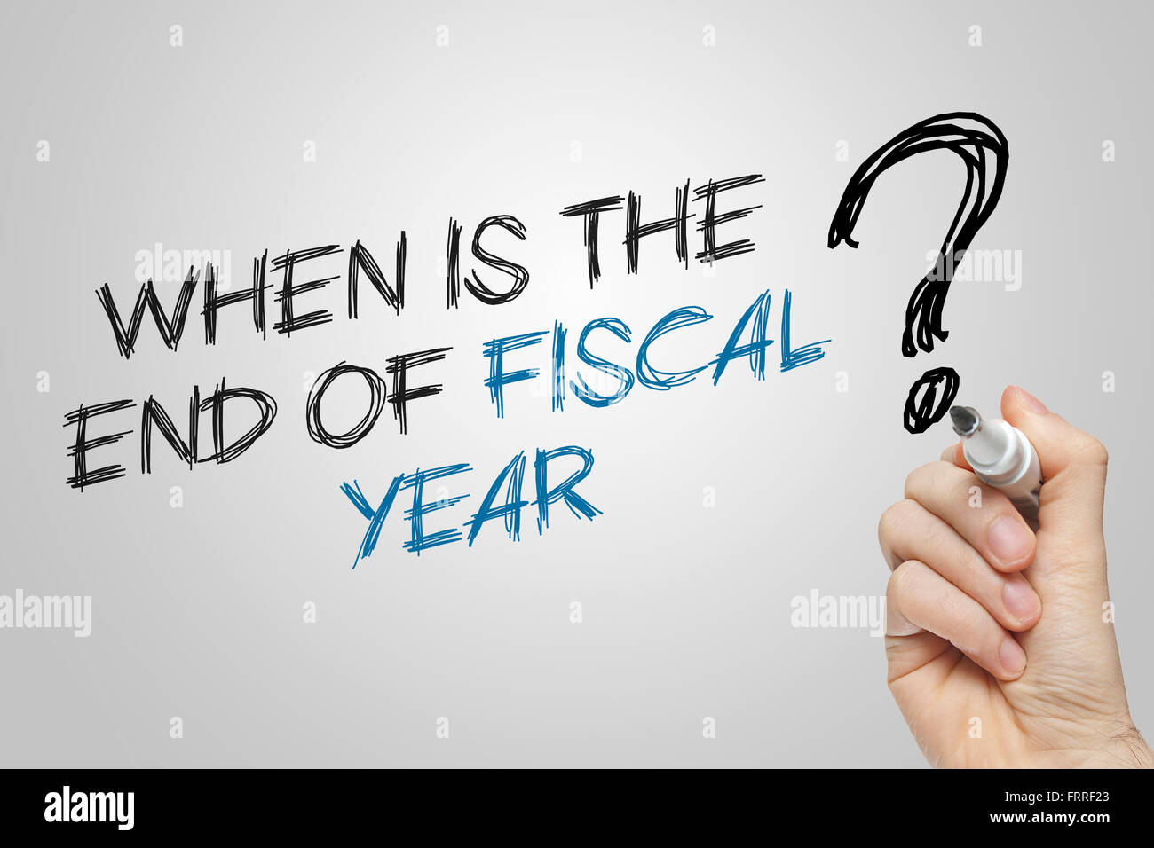 Hand writing when is the end of fiscal year on grey background Stock ...