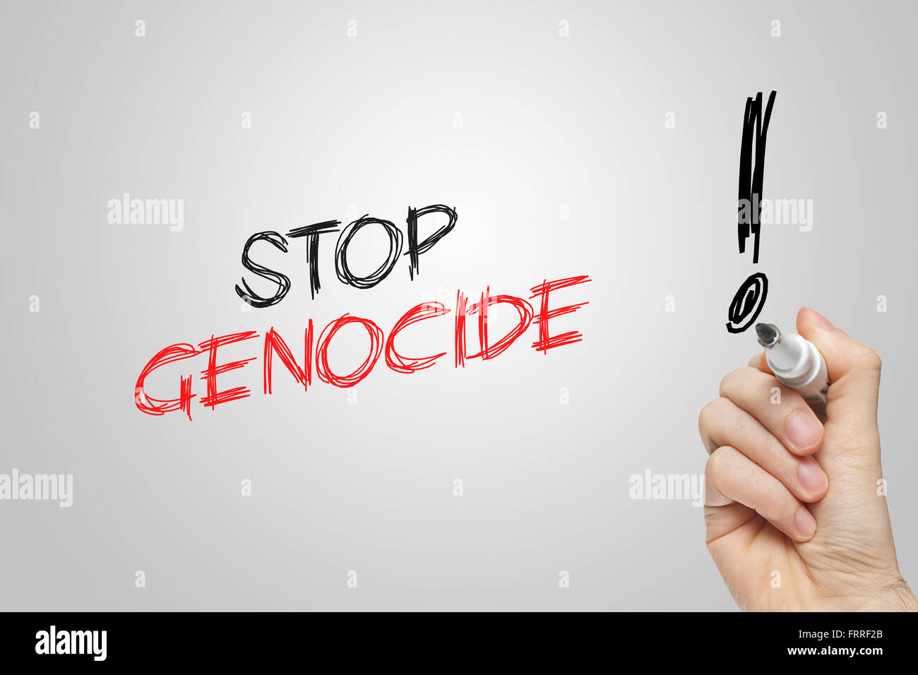 Hand writing stop genocide on grey background Stock Photo - Alamy