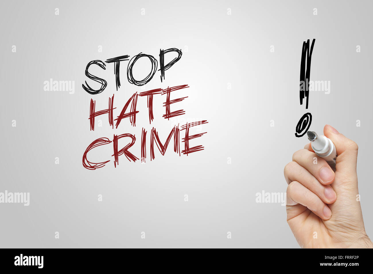 Hand writing stop hate crime on grey background Stock Photo - Alamy