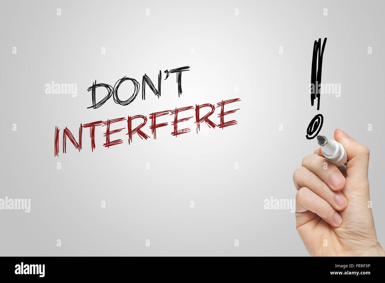 Hand writing don't interfere on grey background Stock Photo - Alamy