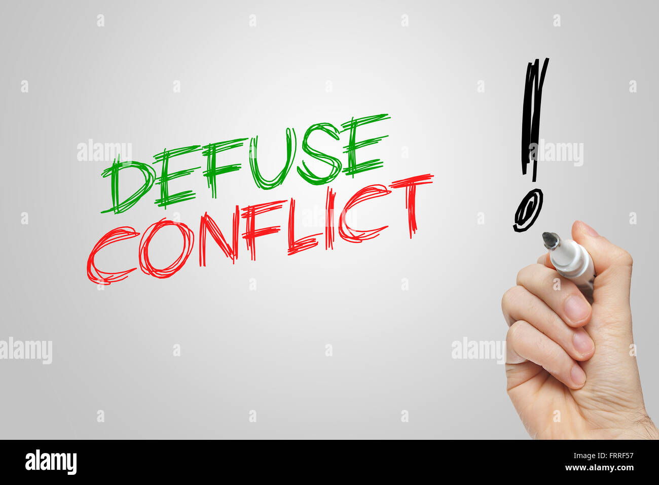 Hand writing defuse conflict on grey background Stock Photo - Alamy