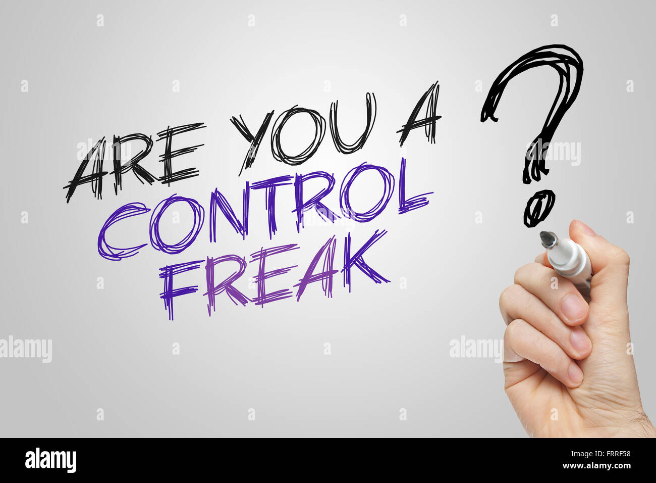 Hand writing are you a control freak on grey background Stock Photo - Alamy