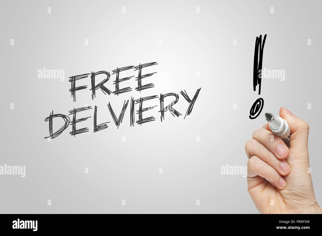 Hand writing free delivery on grey background Stock Photo - Alamy