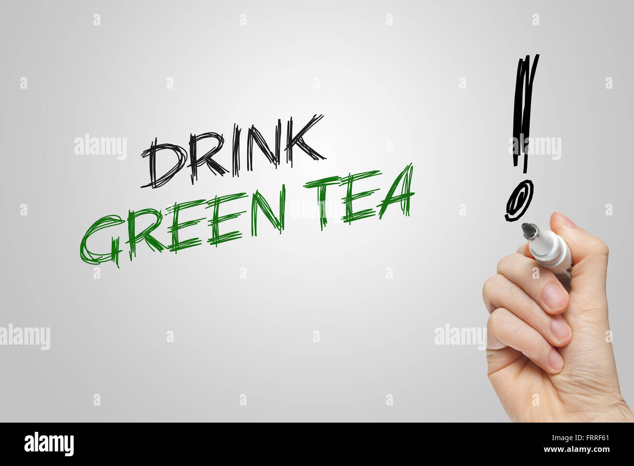 Hand writing drink green tea on grey background Stock Photo - Alamy