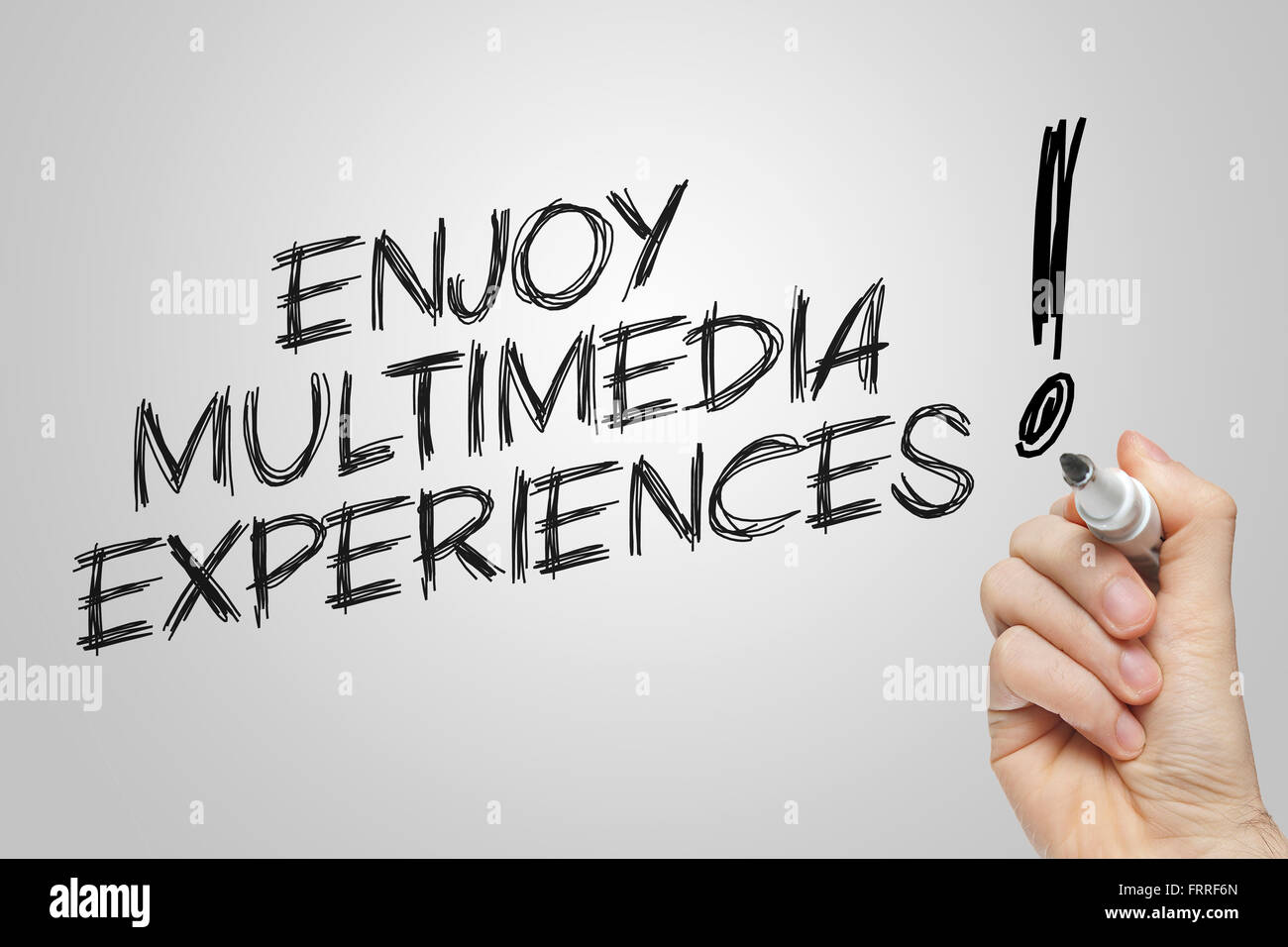 Hand writing enjoy multimedia experiences on grey background Stock ...