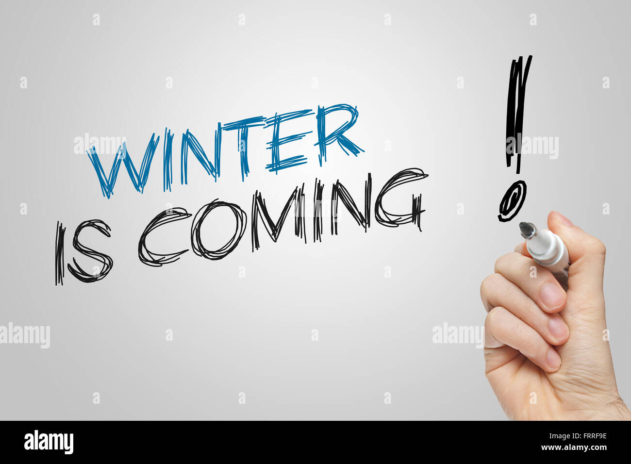Hand writing winter is coming on grey background Stock Photo - Alamy