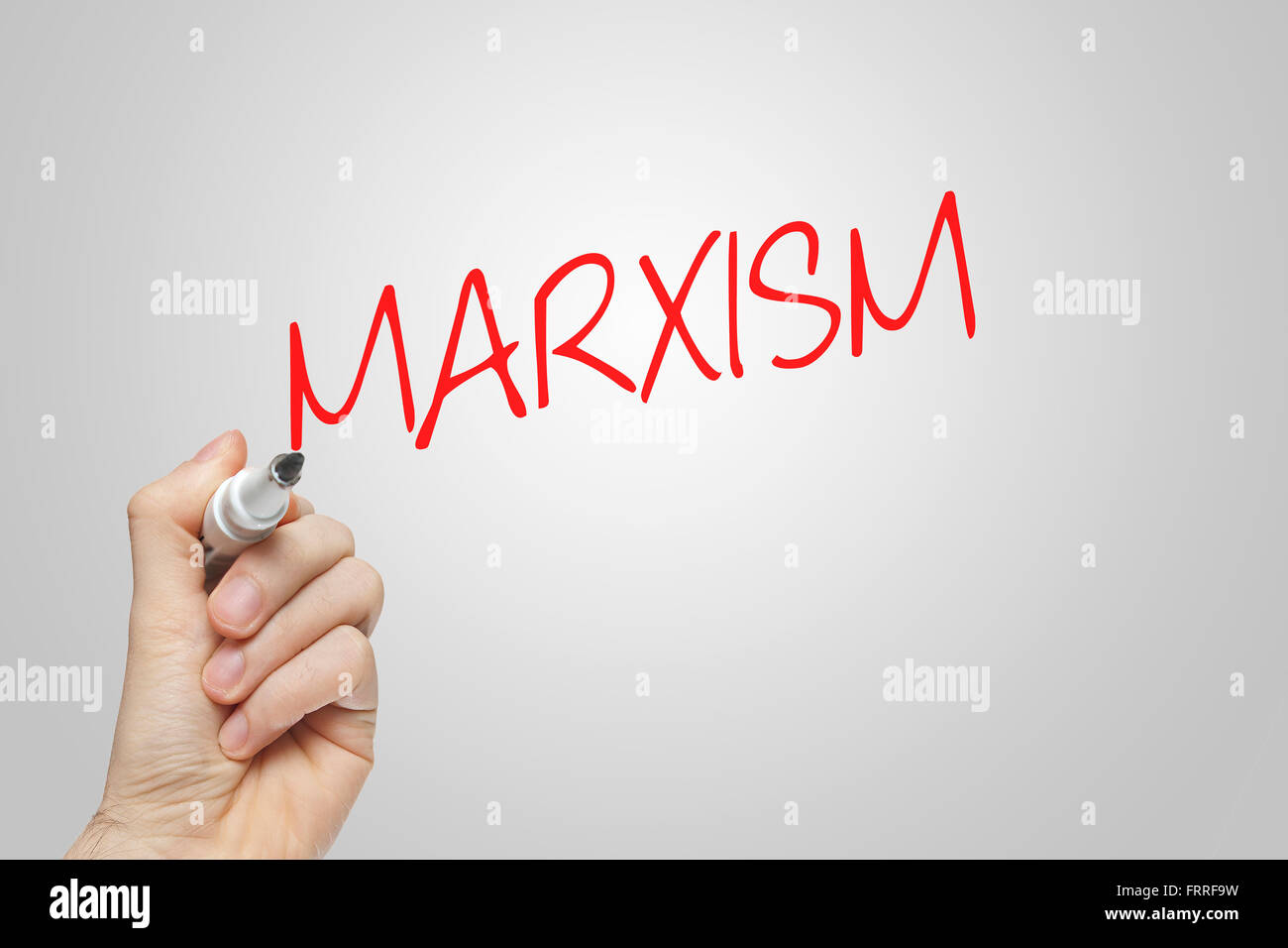 Hand writing marxism on grey background Stock Photo - Alamy