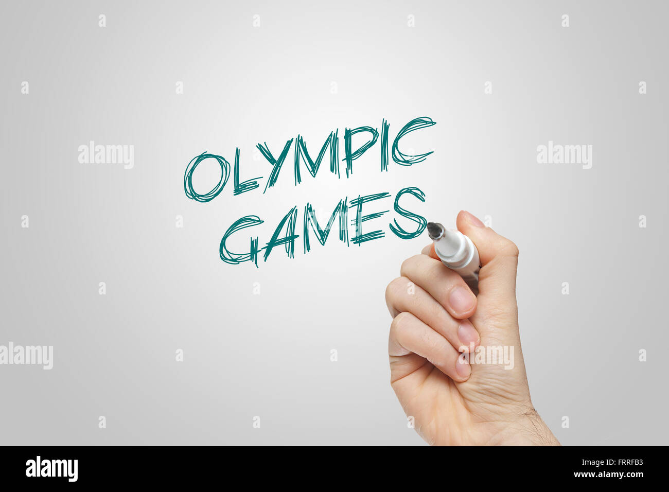 Hand writing olympic games on grey background Stock Photo - Alamy