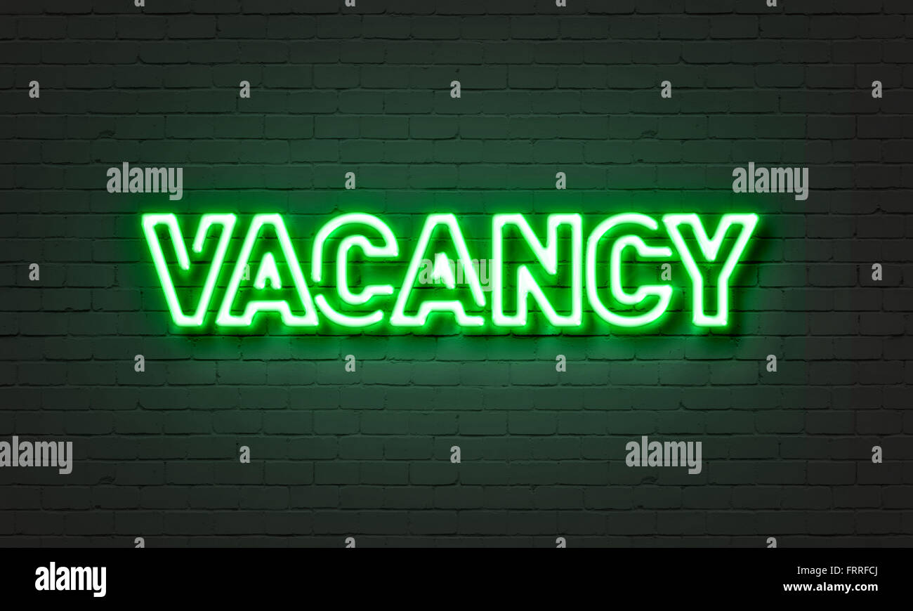 Vacancy neon sign on brick wall background Stock Photo - Alamy