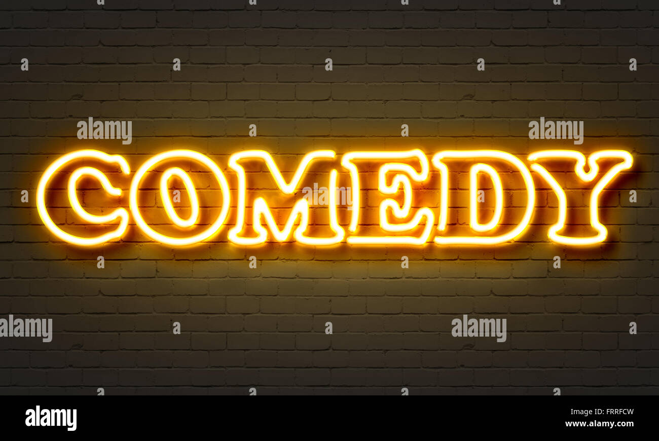 Comedy neon sign on brick wall background Stock Photo - Alamy
