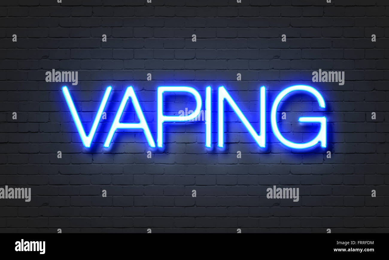 Vaping neon sign on brick wall background Stock Photo - Alamy