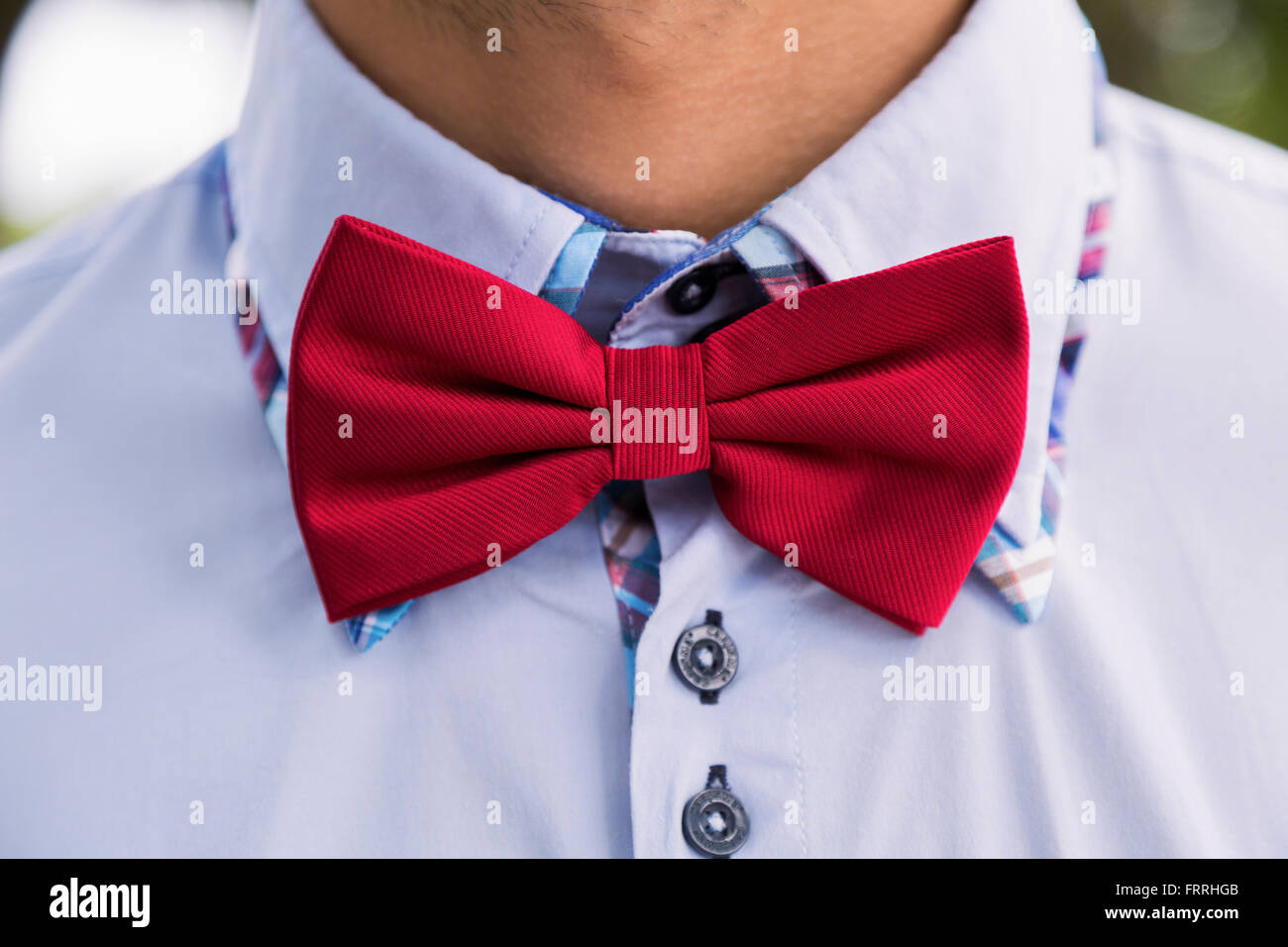 Man in blue shirt and red bow-tie Stock Photo - Alamy
