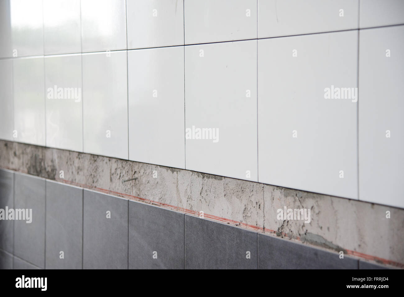 Plasterer tiled wall Stock Photo - Alamy