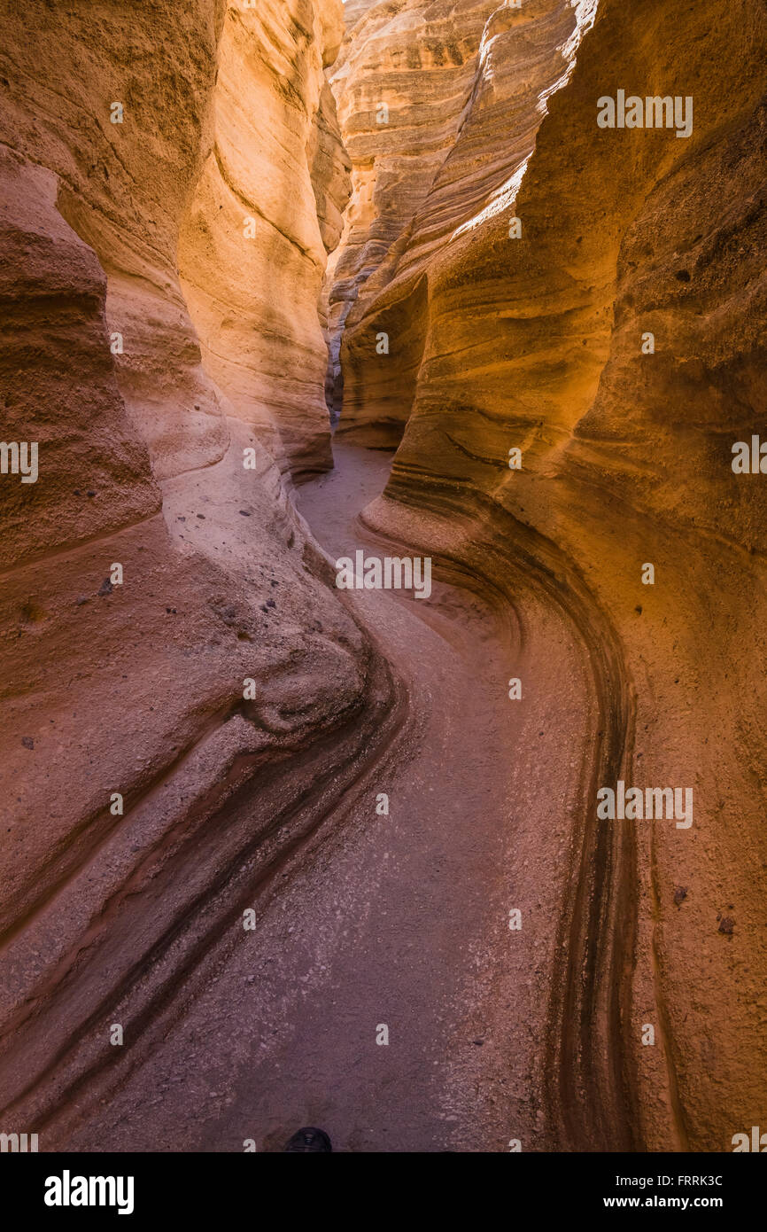 Hiking through the narrow slot canyon along the Slot Canyon Trail at ...