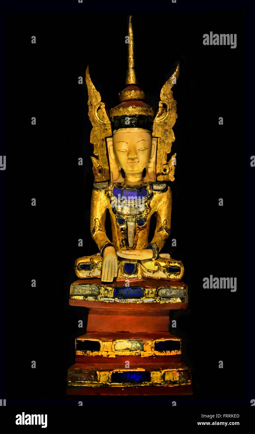 Buddha in royal finery, sitting cross-legged on a high and richly ...