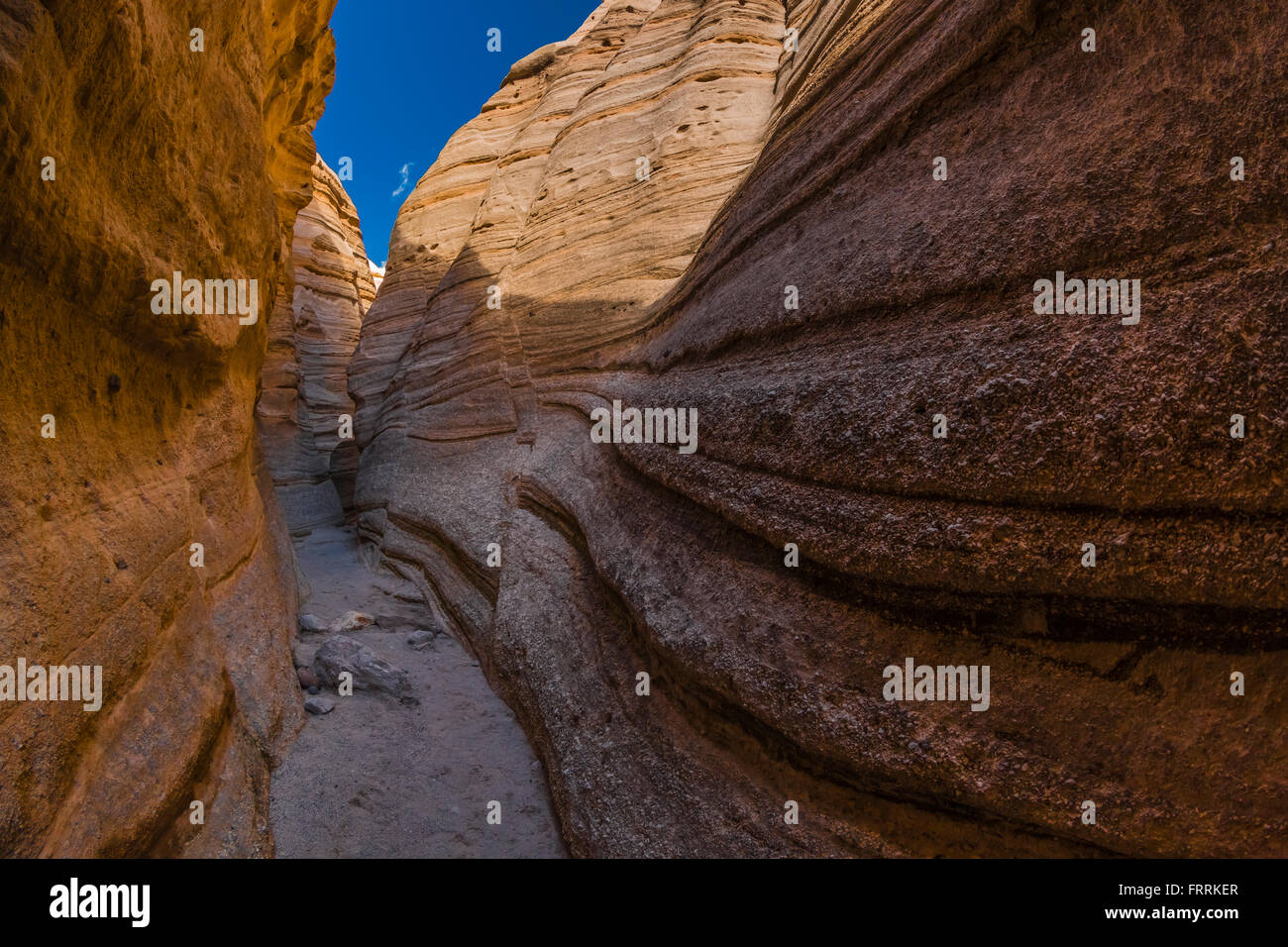 Hiking through the narrow slot canyon along the Slot Canyon Trail at ...