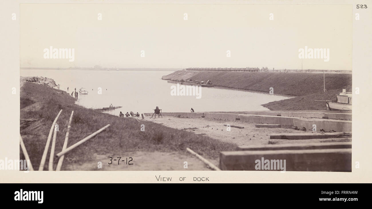 A photograph showing the view of a dock area with railroad bridges ...