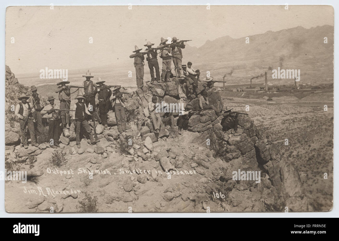 The photograph shows soldiers engaged in an outpost skirmish during the ...