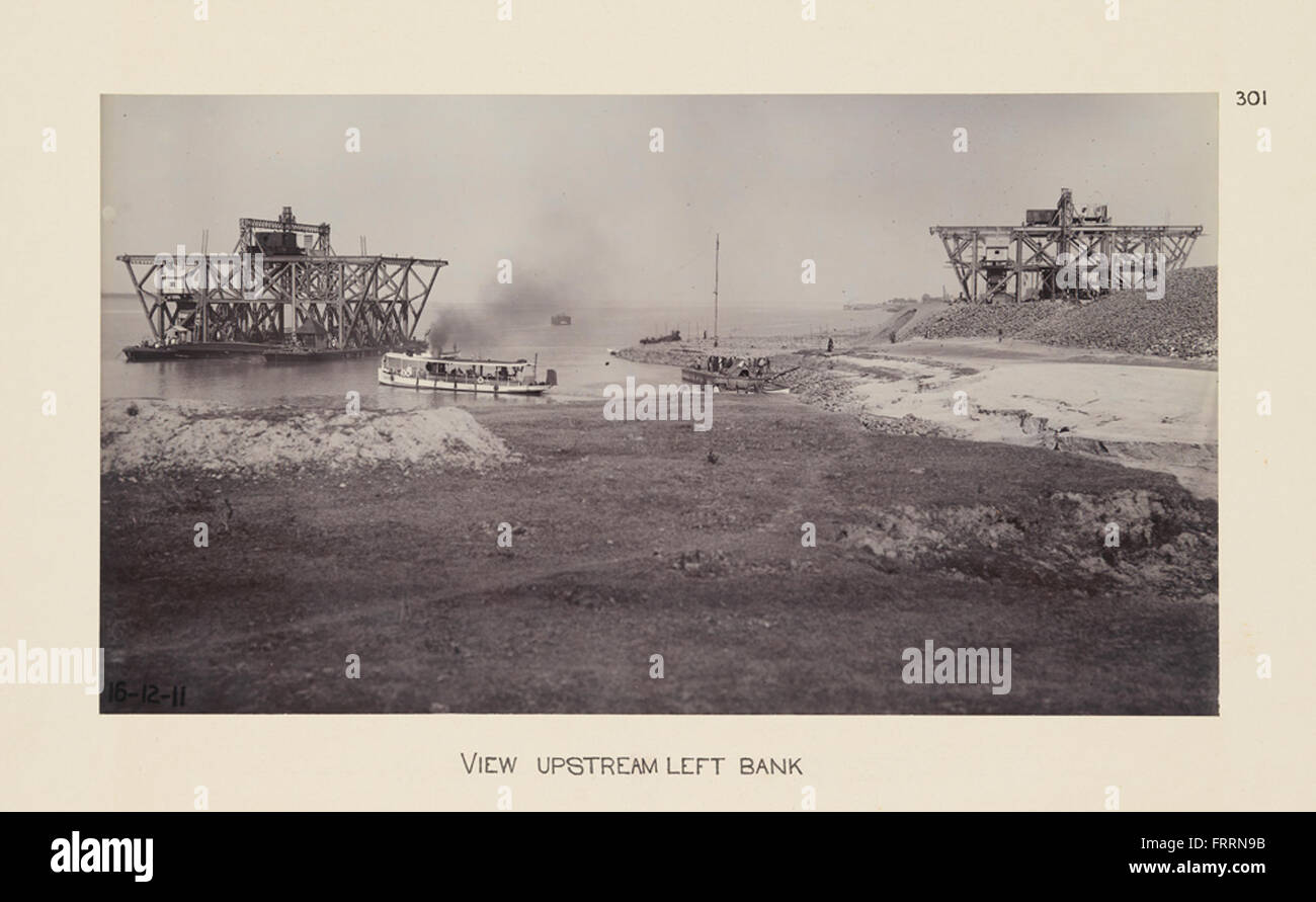 A photograph showing an upstream view of a railroad bridge construction ...