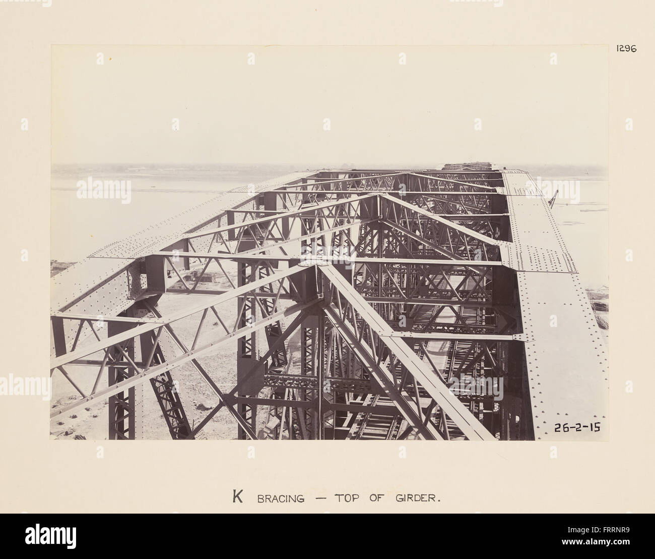 The photograph shows K bracing being installed at the top of a girder ...