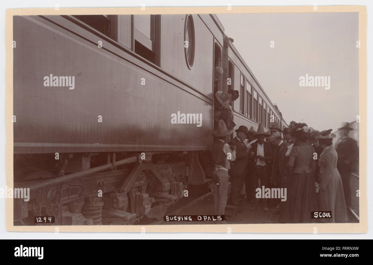 A photograph showing men and women involved in the handling of opals ...
