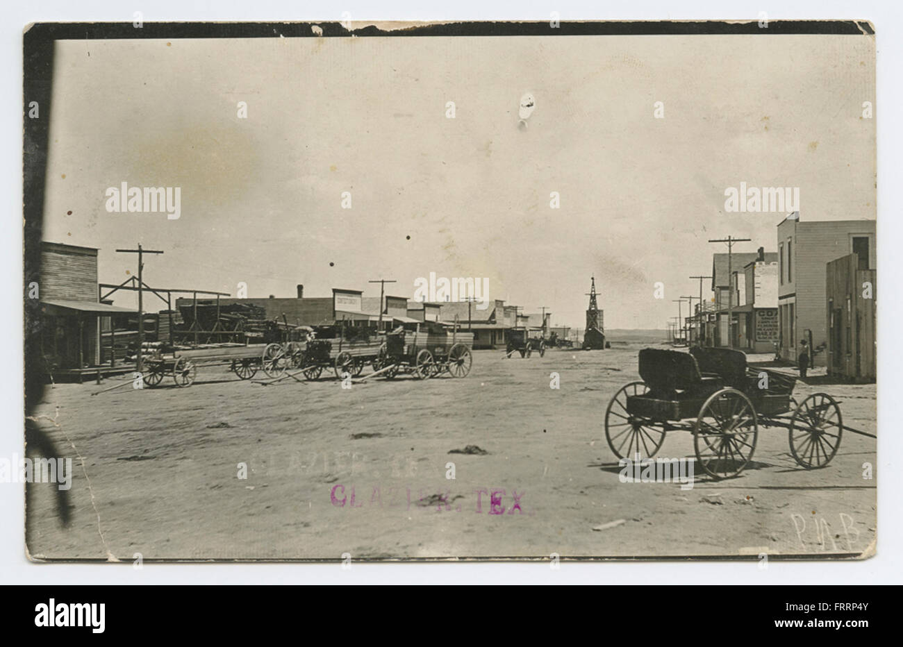 A photograph of commercial buildings in Glazier, Texas, with carriages ...