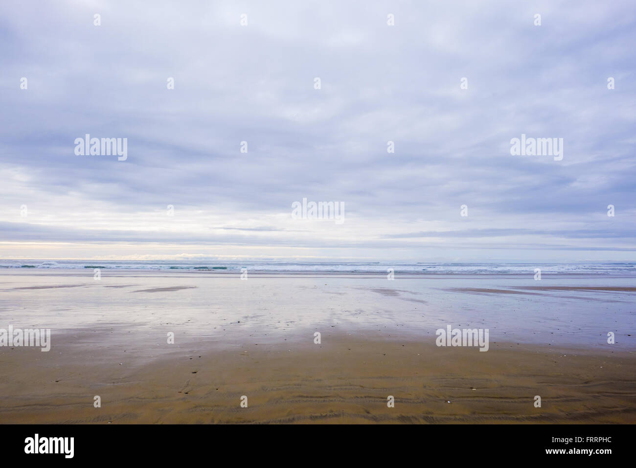 Large beach at low tide on the Oregon Coast showing the coastline with ...