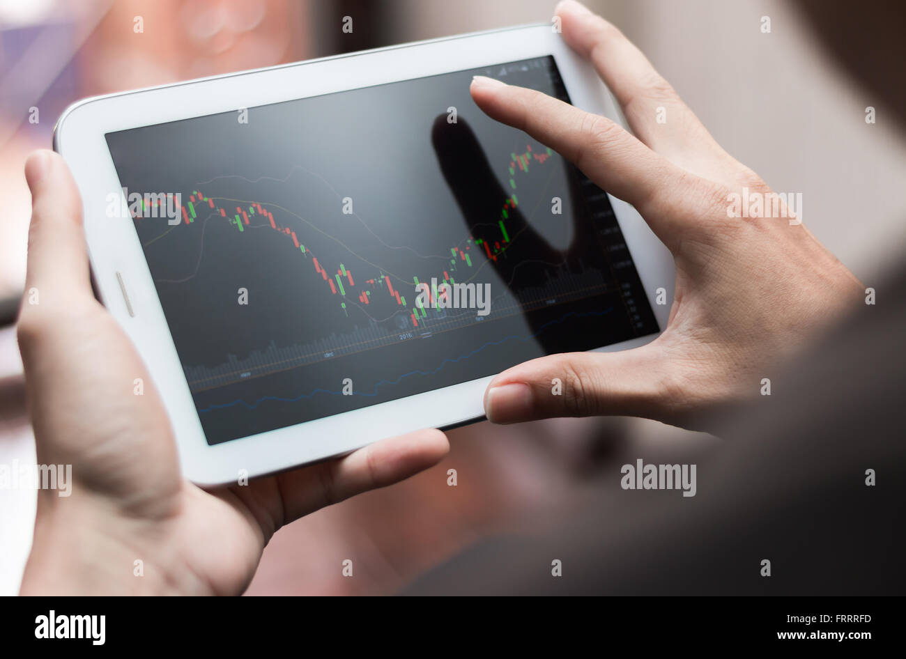 a man checking stock market on tablet, smartphone Stock Photo - Alamy