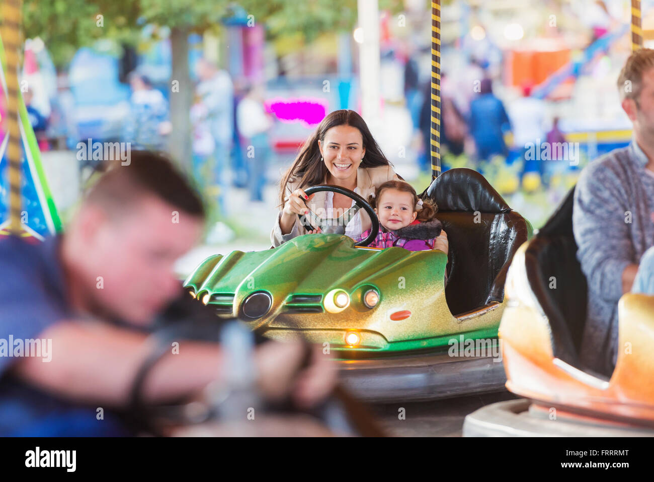 Mother and daughter in bumper car at fun fair Stock Photo - Alamy