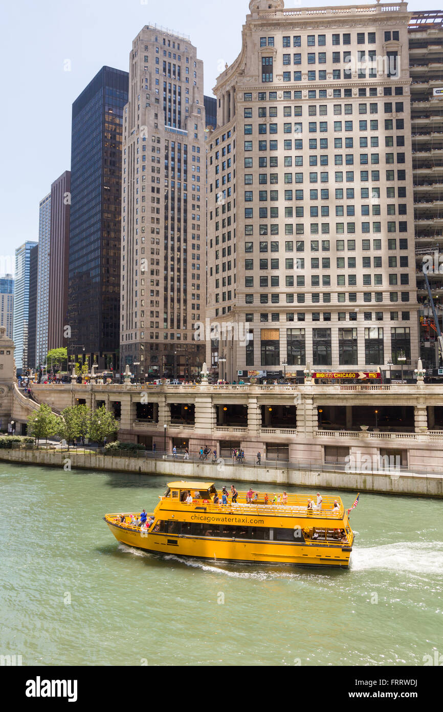 The water taxi travels down the Chicago River near the DuSable Bridge ...