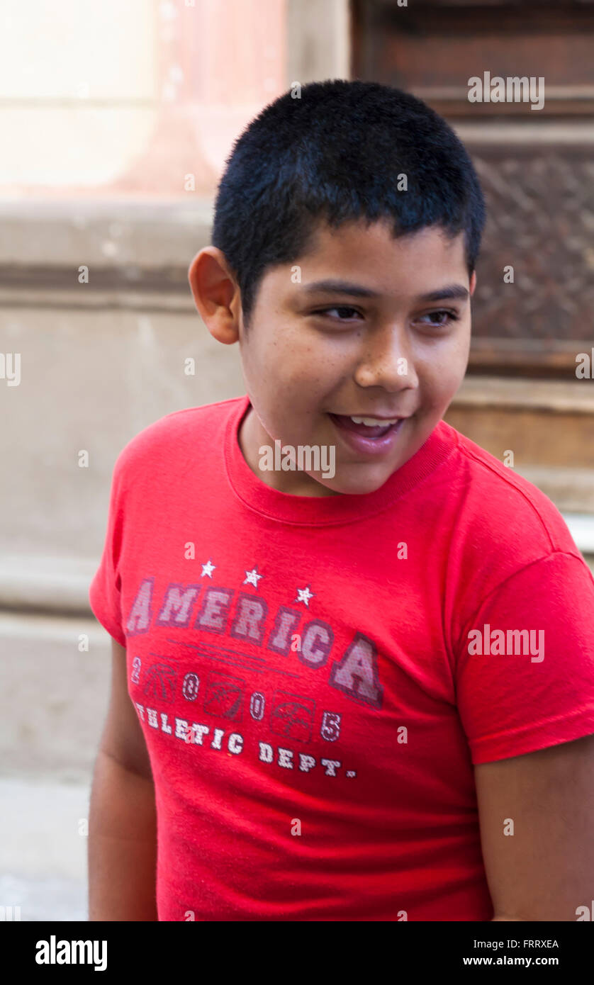 Daily life in Cuba - portrait of young boy wearing red America Athletic ...