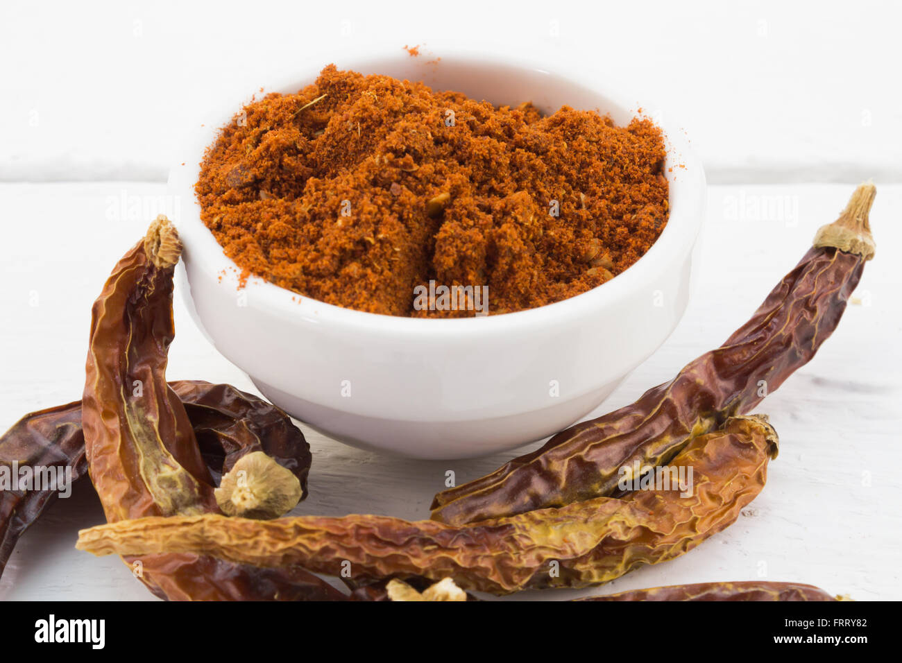 Photo of dried ground chili spice and whole dried chilis Stock Photo ...