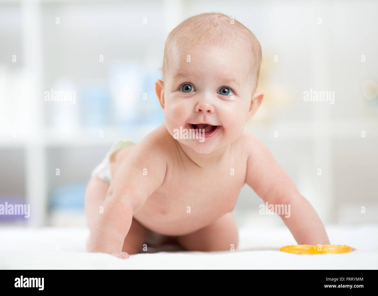 Baby laughing, creeping and playing in nursery Stock Photo - Alamy