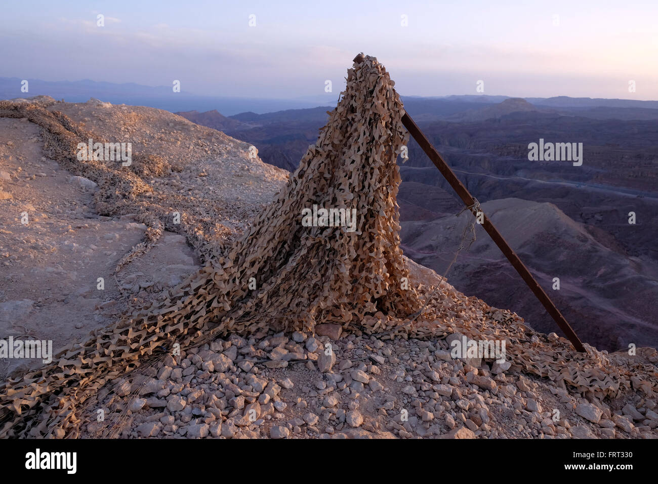 Large perforated camouflaged military netting at a viewing platform in ...