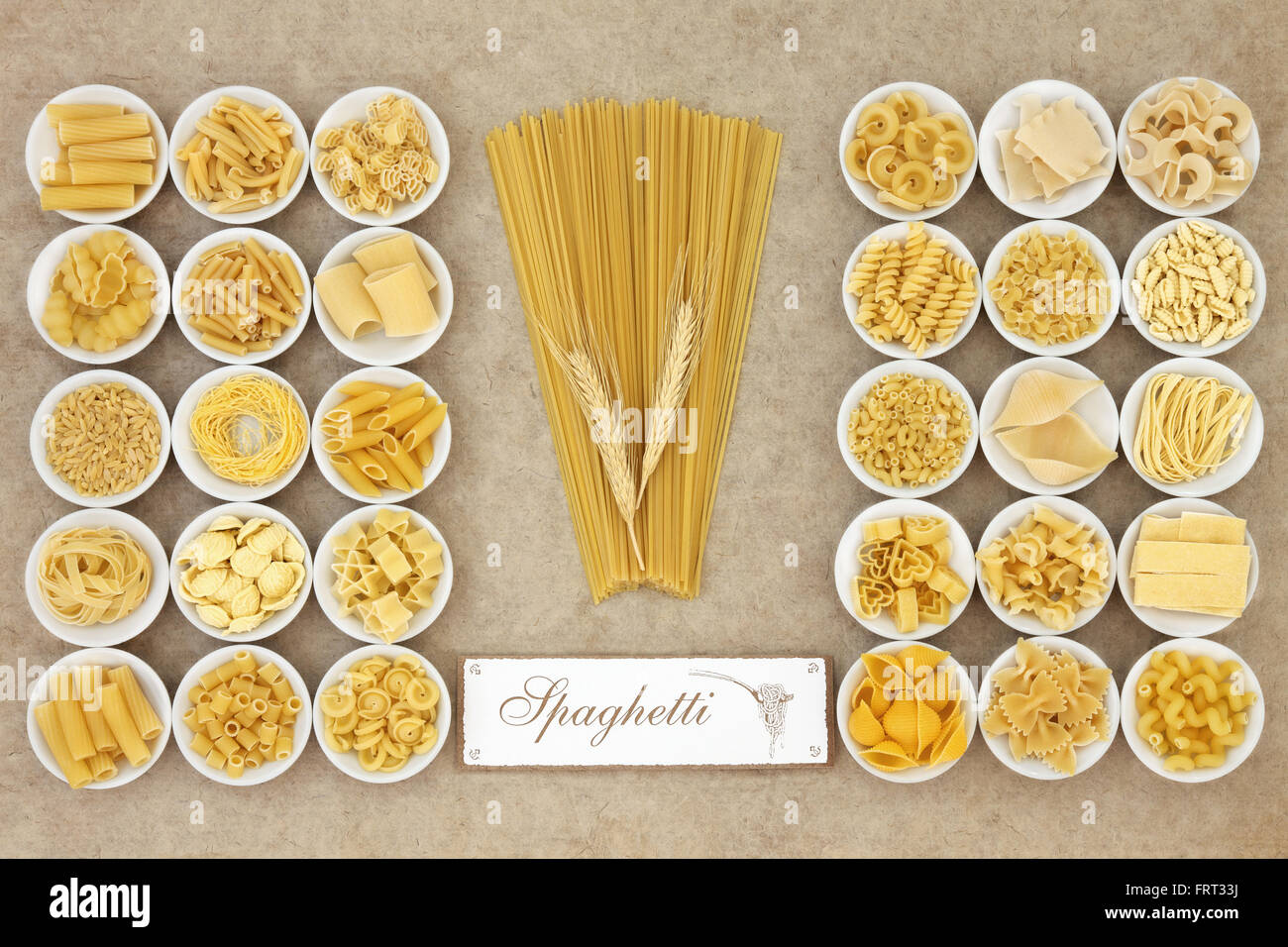 Dried pasta food varieties in round porcelain bowls with old spaghetti ...