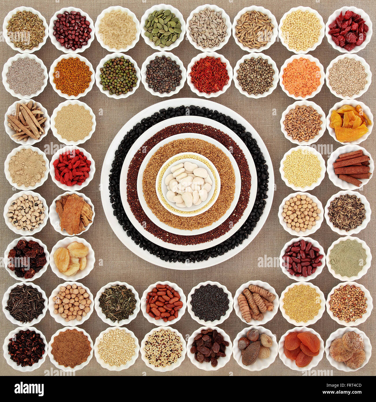 Large dried super food sampler in porcelain bowls forming an abstract ...