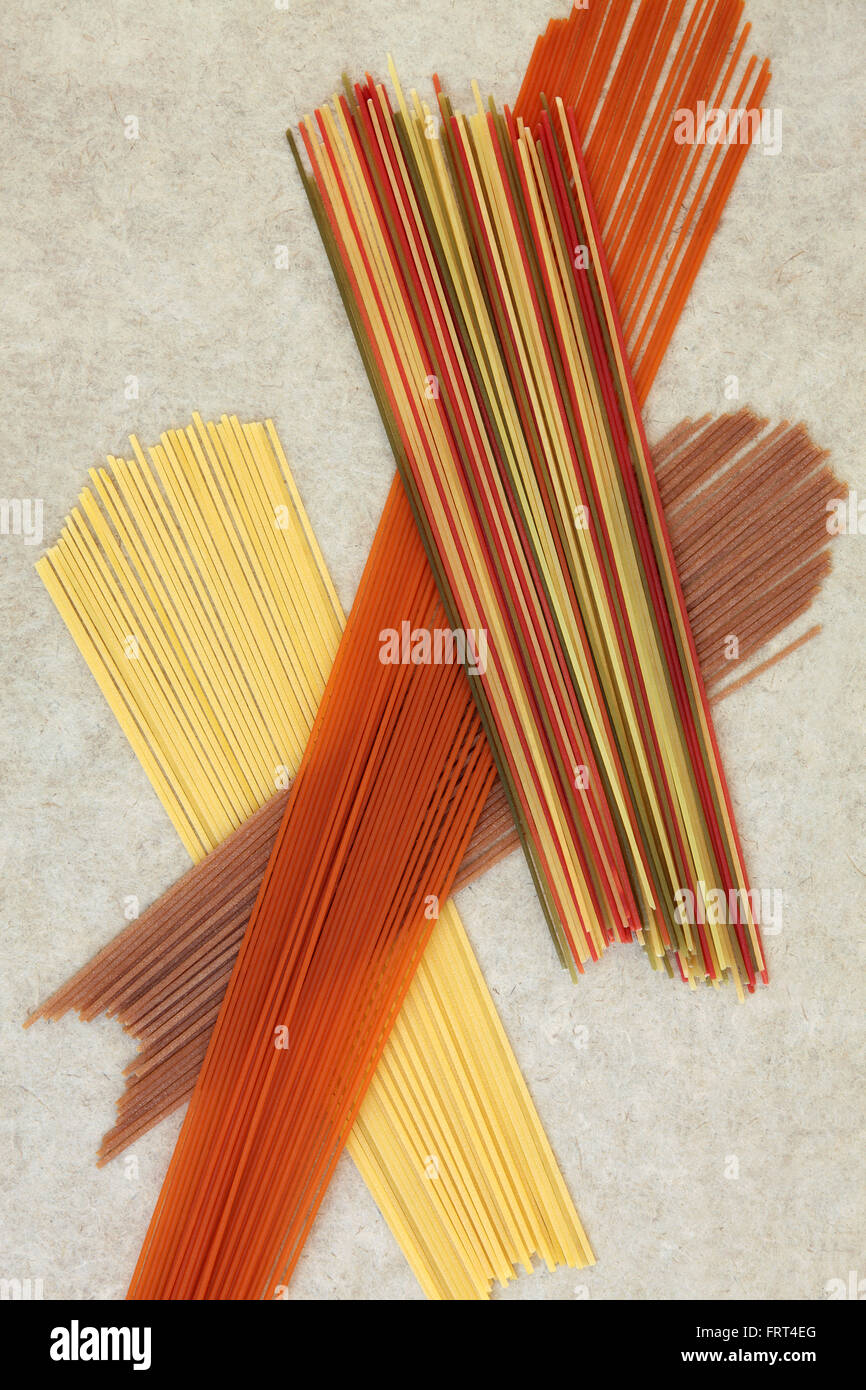 Dried spaghetti pasta food abstract background over natural hemp paper ...