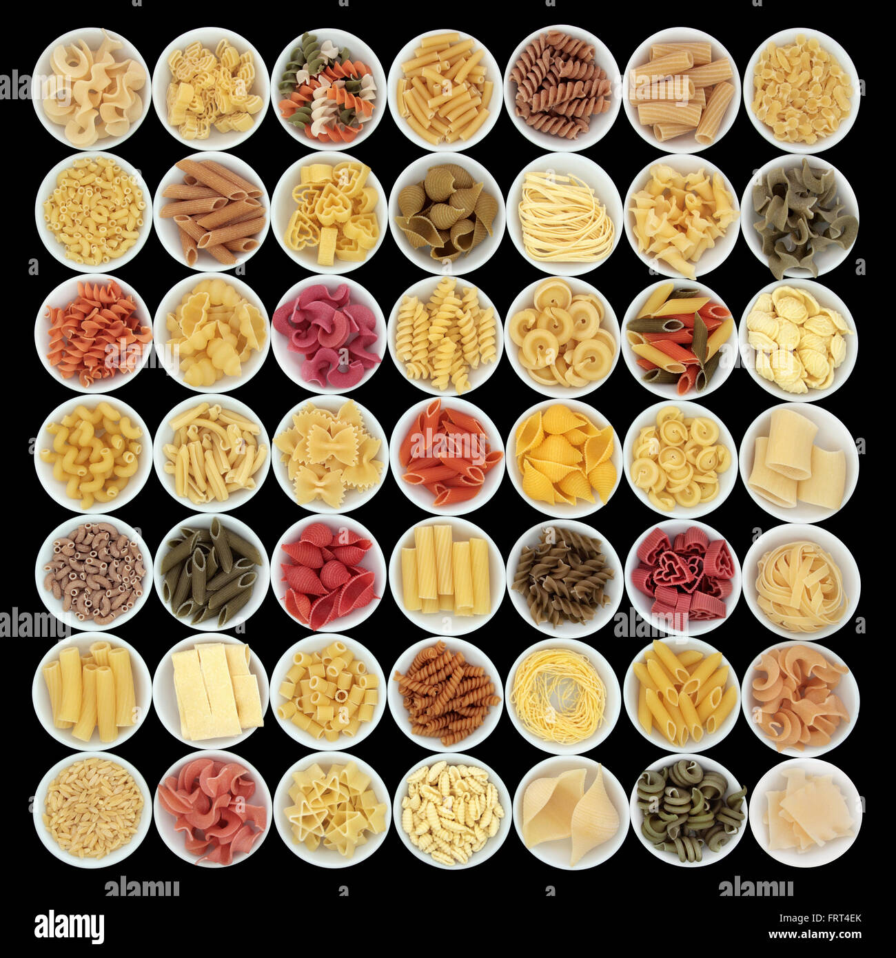 Large dried pasta spaghetti selection in round china bowls over black ...
